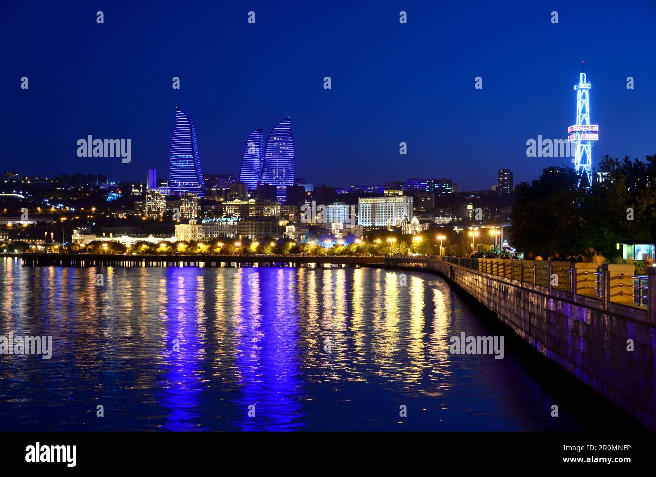 Evening view from the waterfront over Baku Bay to the Flame Towers with ...