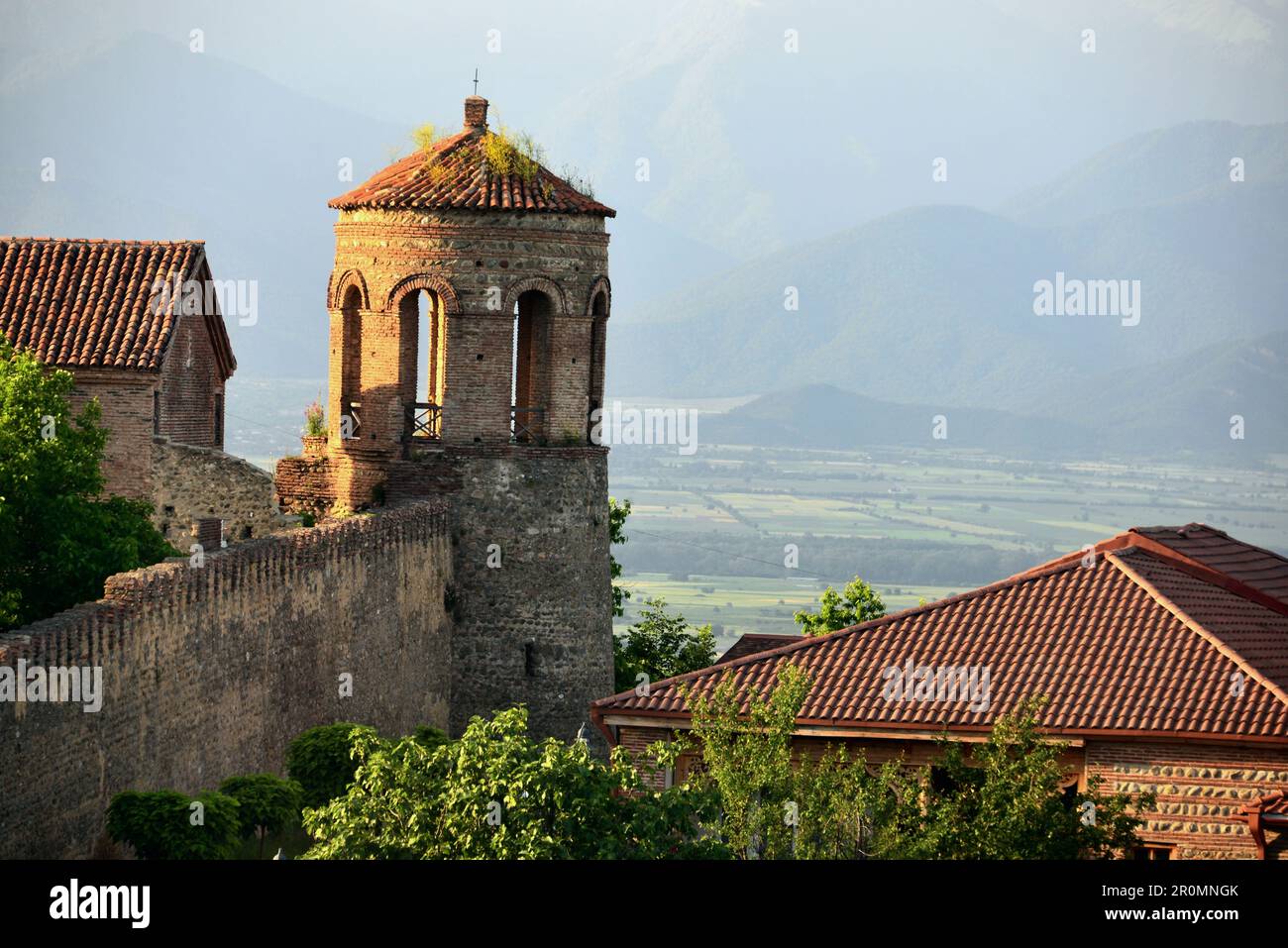 Medieval stone tower of the fortress of Telavi with green landscape and ...