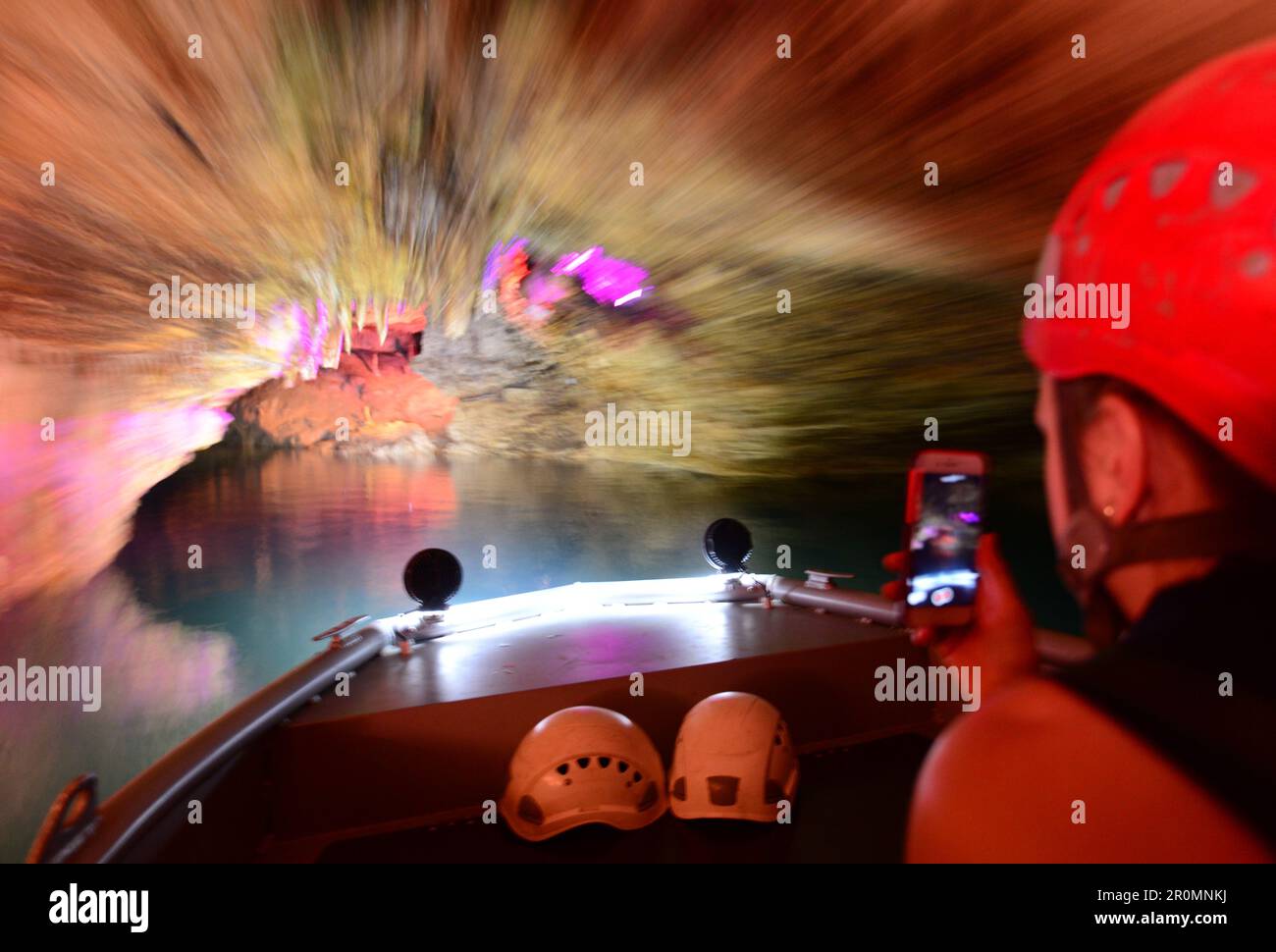 Tourist takes pictures on the boat that runs the drain of the ...