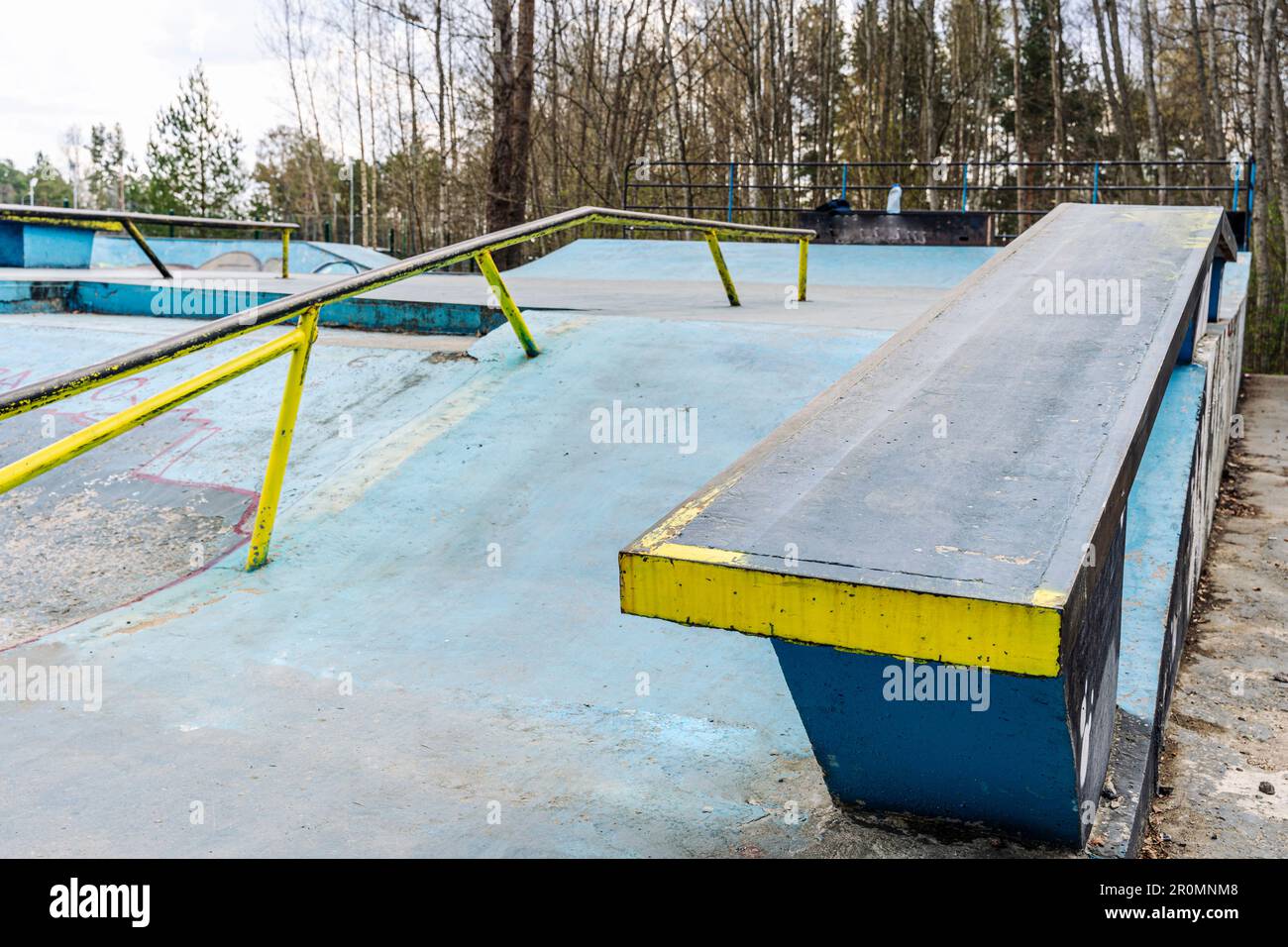 a ramp with an iron ramp for jumping in a skate park Stock Photo - Alamy