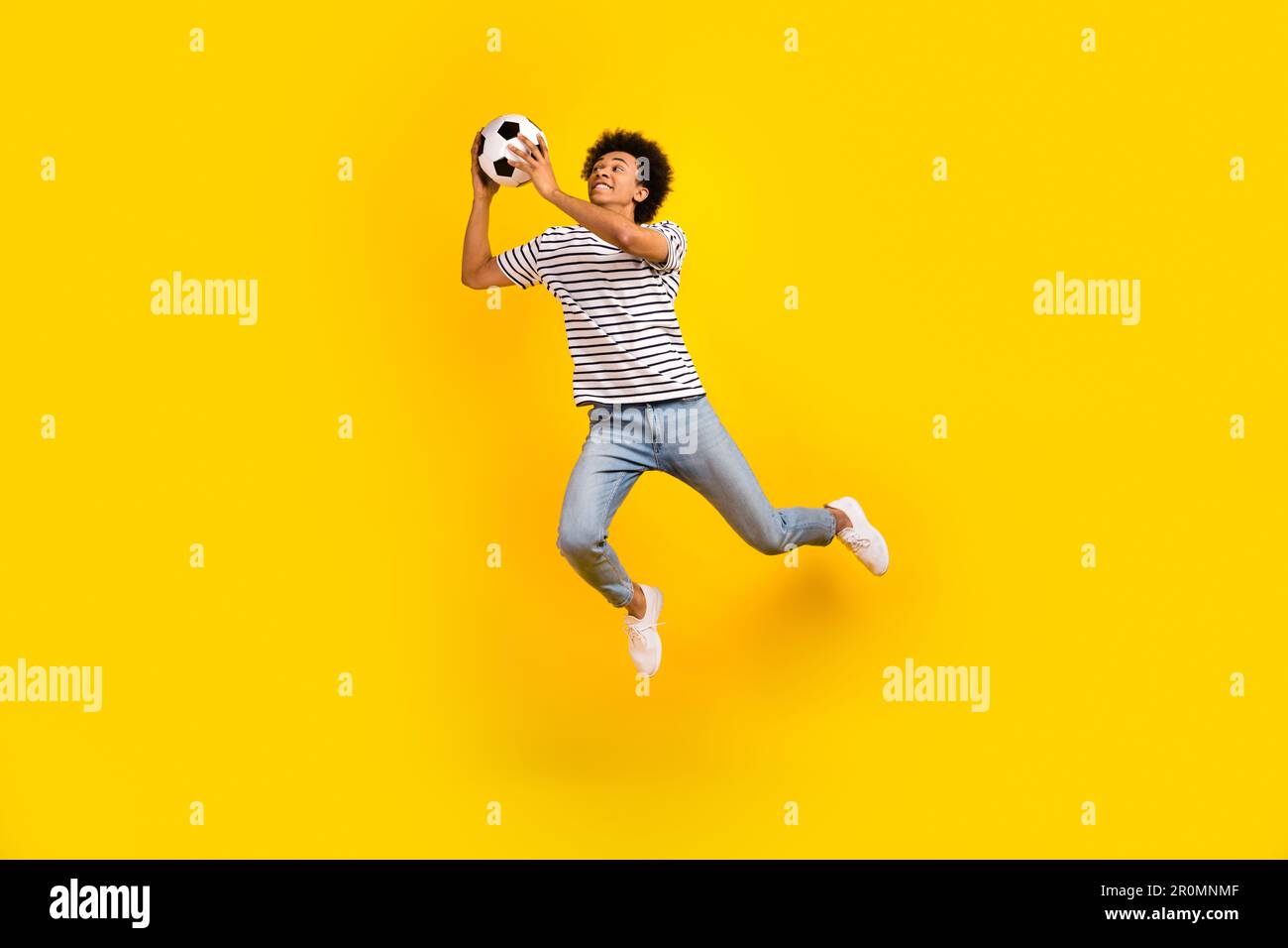 Full body length photo of young professional sportsman goalkeeper catch ...