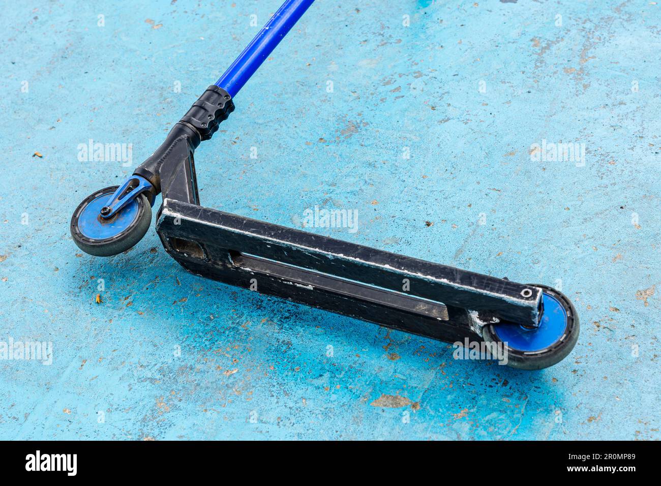 the scratched scooter lies after falling to the ground Stock Photo - Alamy