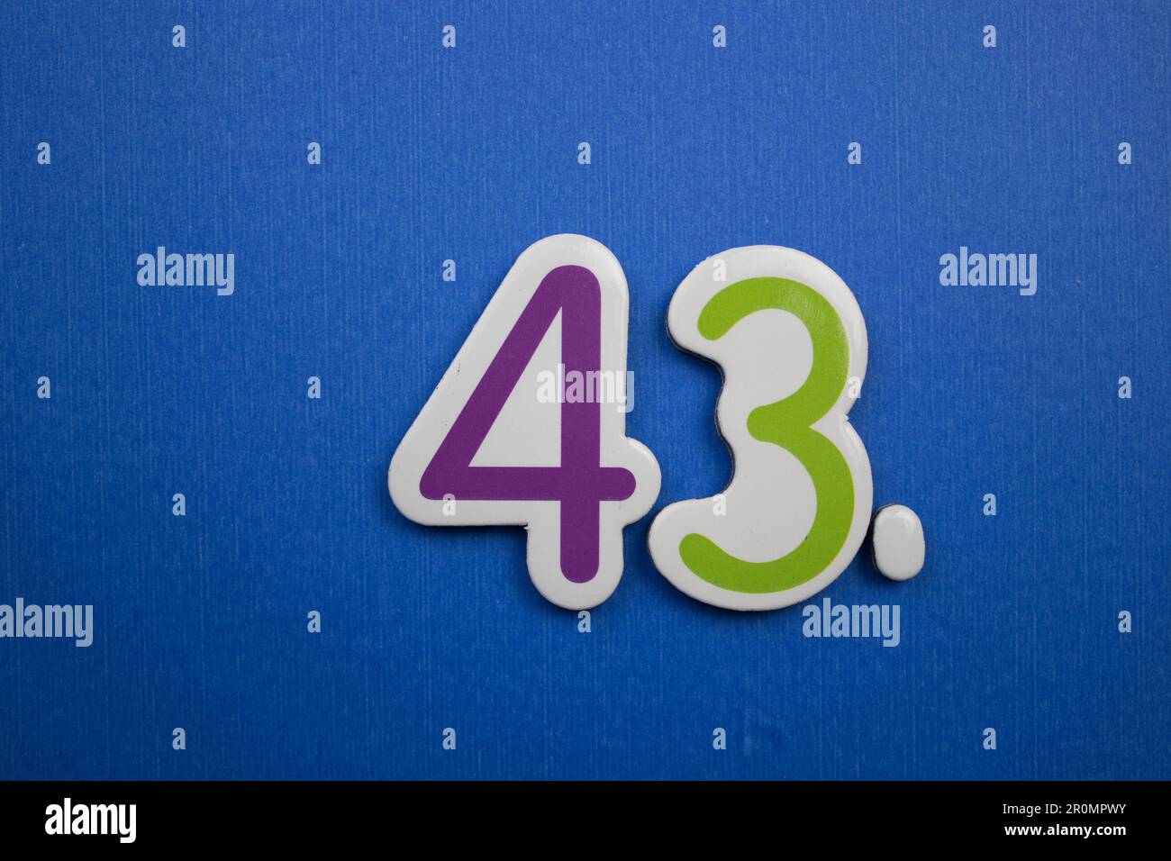 The number 43, placed on a blue background, photographed from above ...