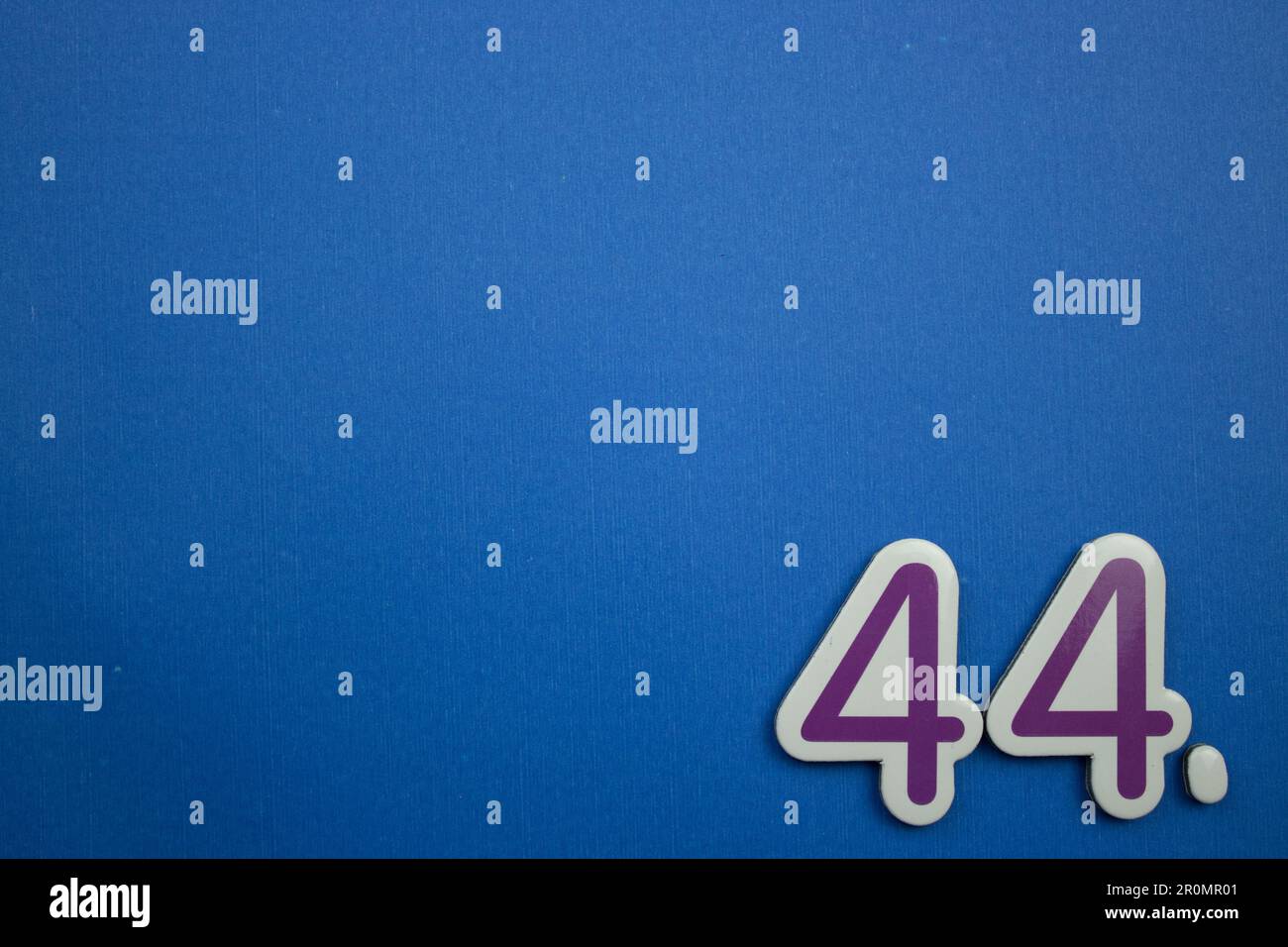 The number 44, photographed from above, purple and dark blue, placed on ...