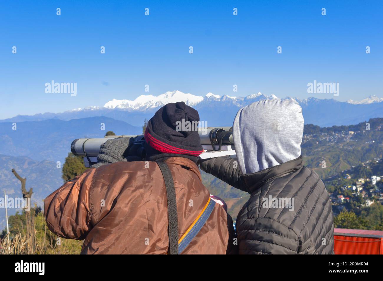 Tourist people looking through binoculars. Rear view Stock Photo - Alamy