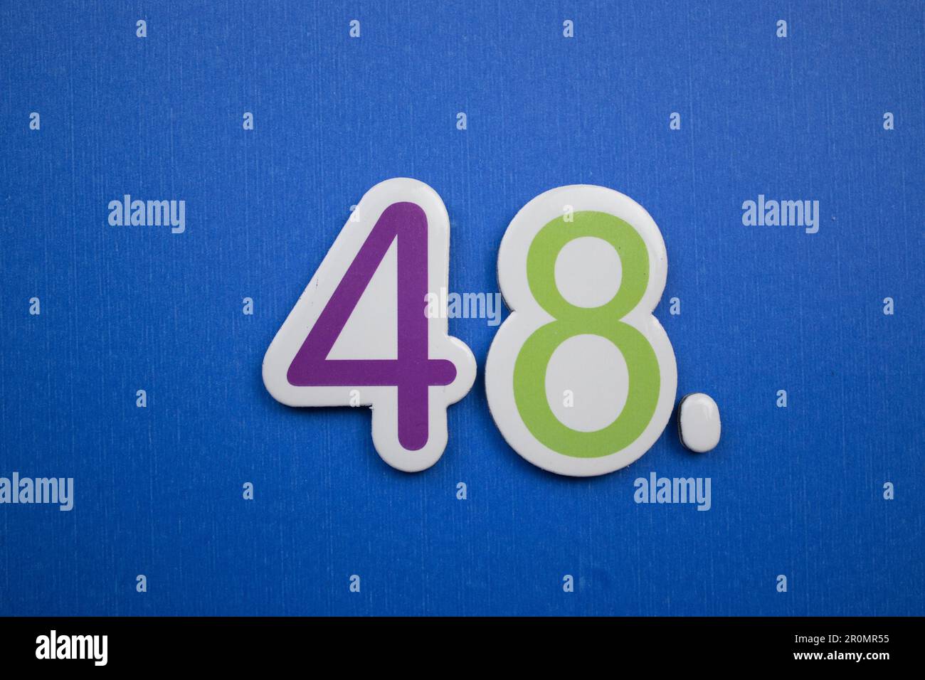 The number 48, placed on a blue background, photographed from above ...