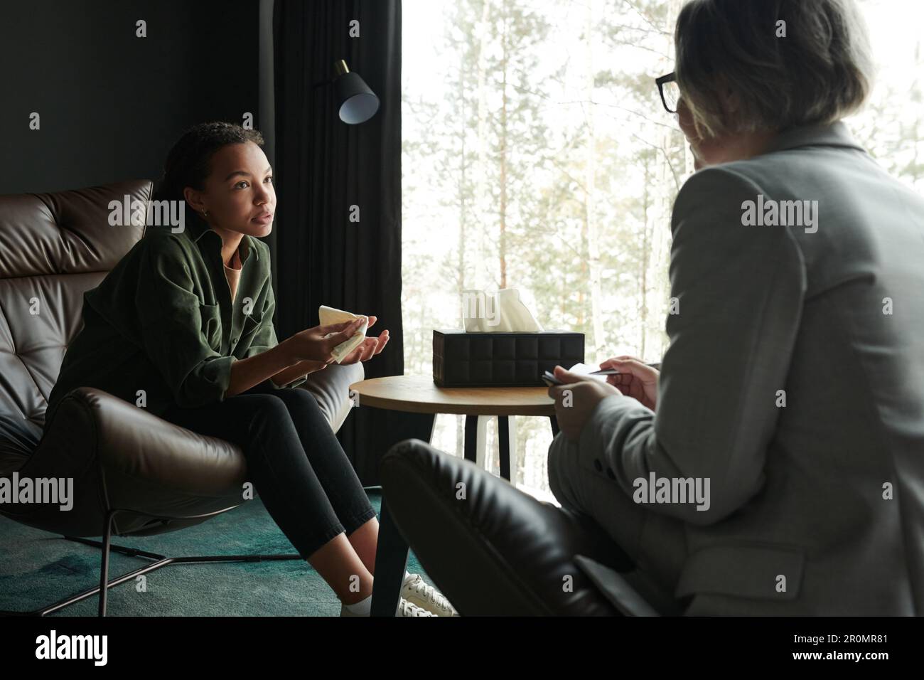 Young stressed African American woman explaining her problem to female ...