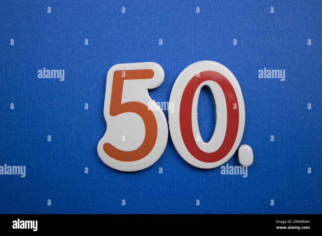 The number 50, placed on a blue background, photographed from above ...