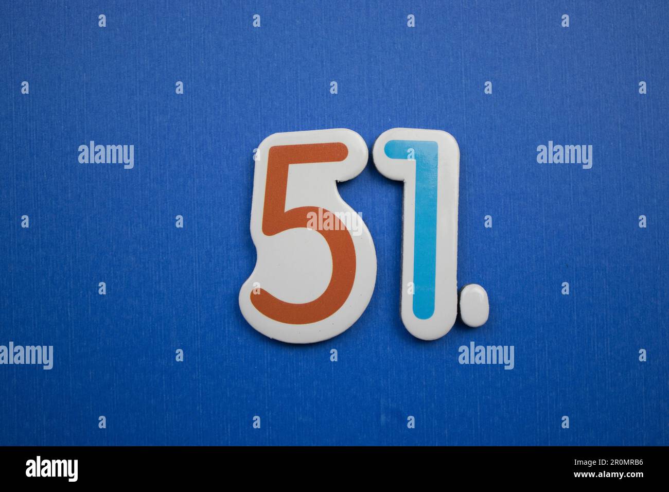 The number 51, placed on a blue background, photographed from above ...