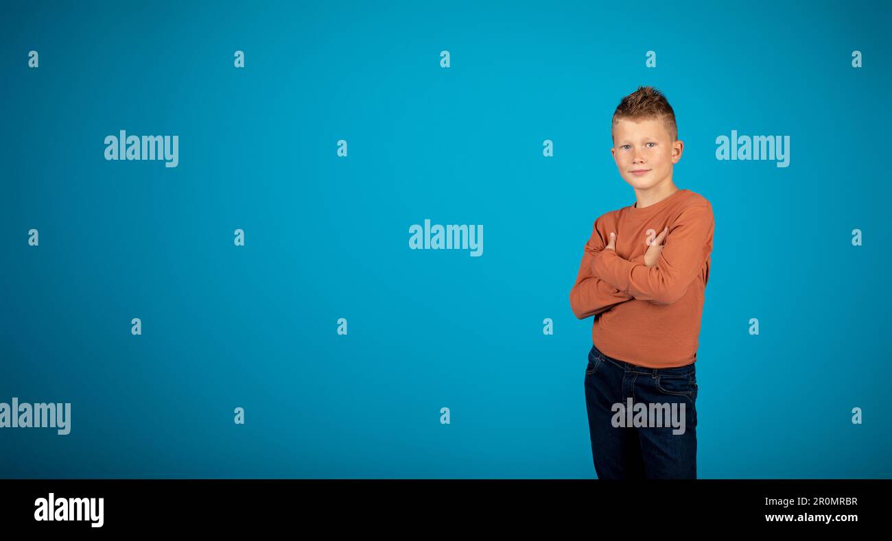 Smiling Caucasian Boy Standing With Folded Arms Over Blue Background ...