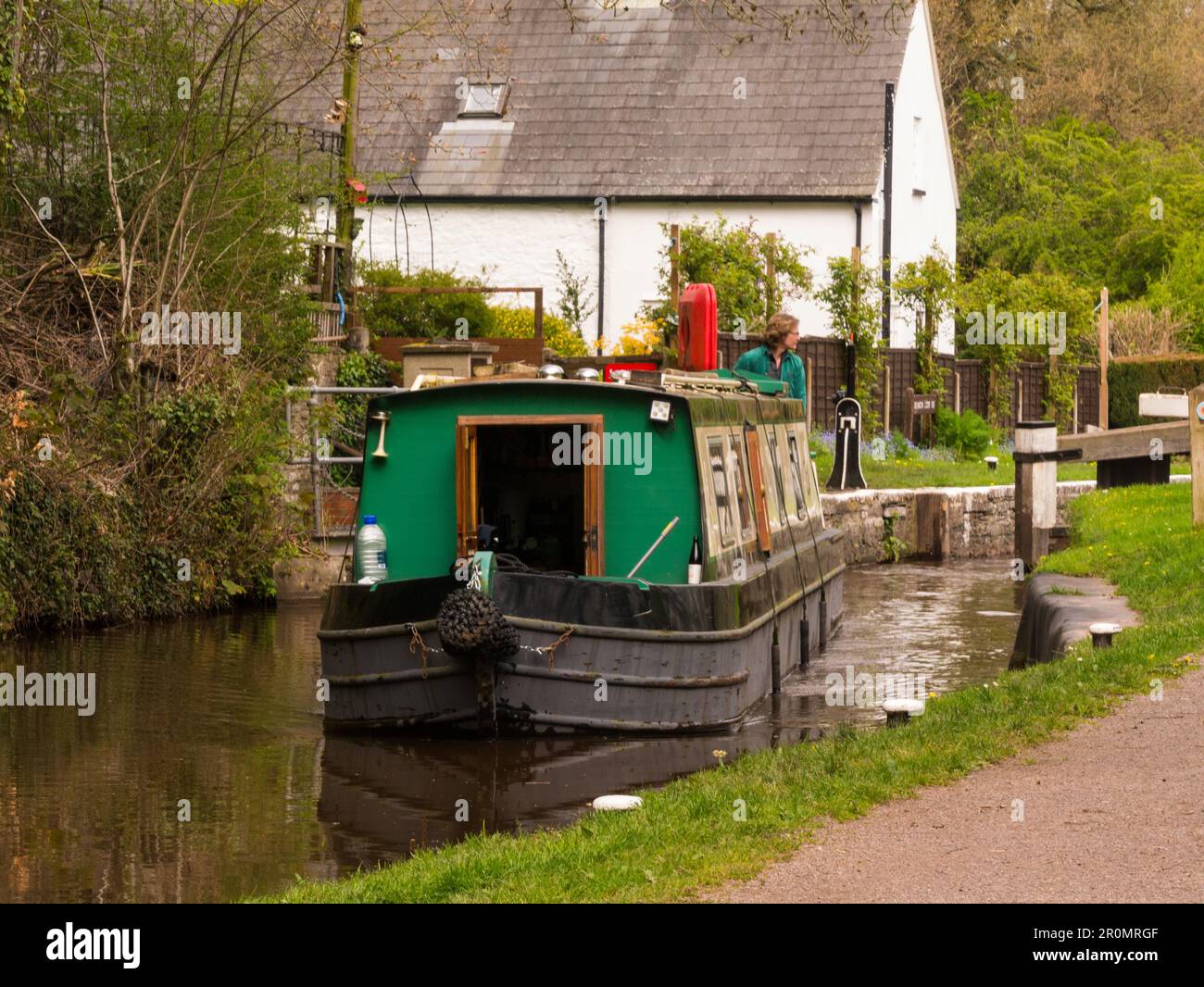 Woman steering narrowboat out of Brynich lock on Monmouthshire and ...