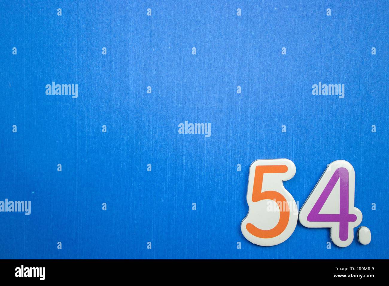 The number 54, orange and purple, photographed from above, placed on ...