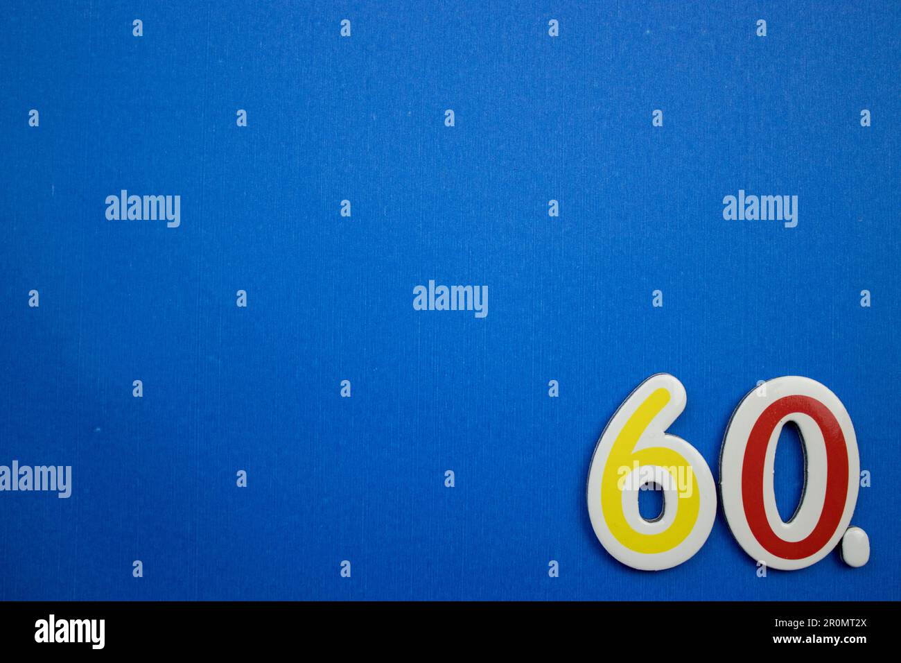 The number 60, placed on the edge of the blue background, photographed ...