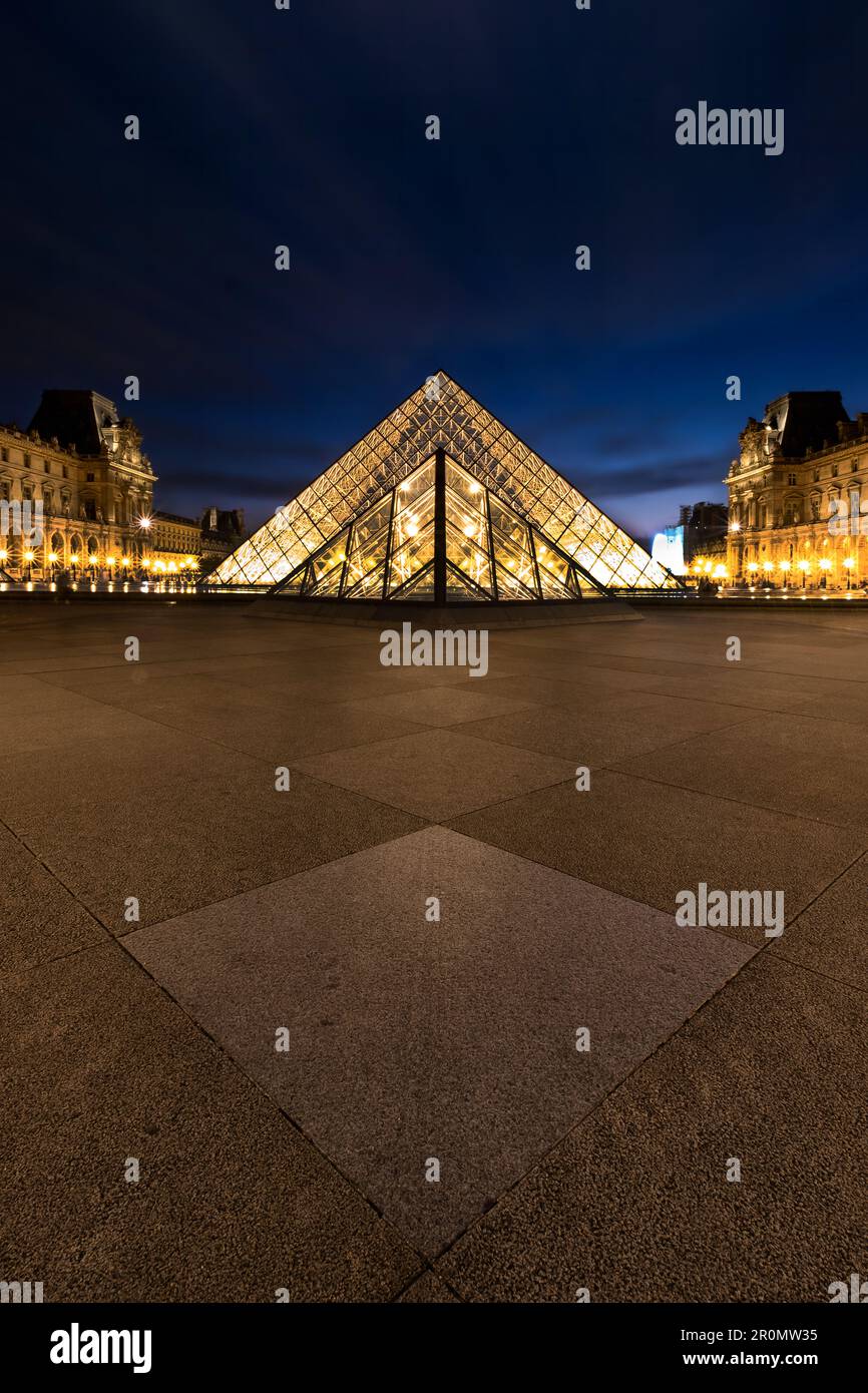 Courtyard of the Louvre with a view of the illuminated pyramid at the ...