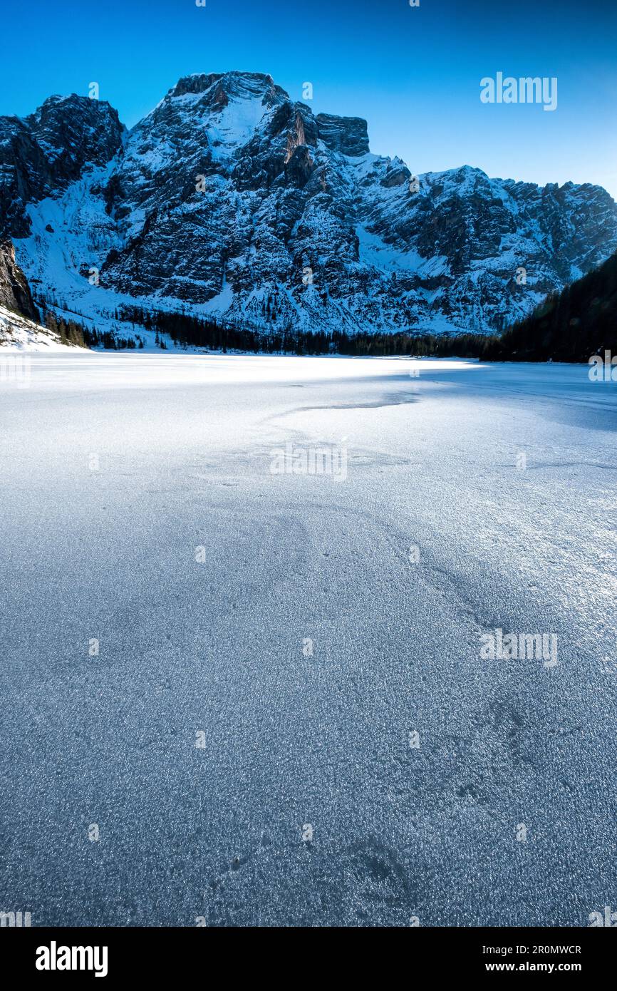 Snow layer on frozen Lake Braies, in the background Mountain massif of ...
