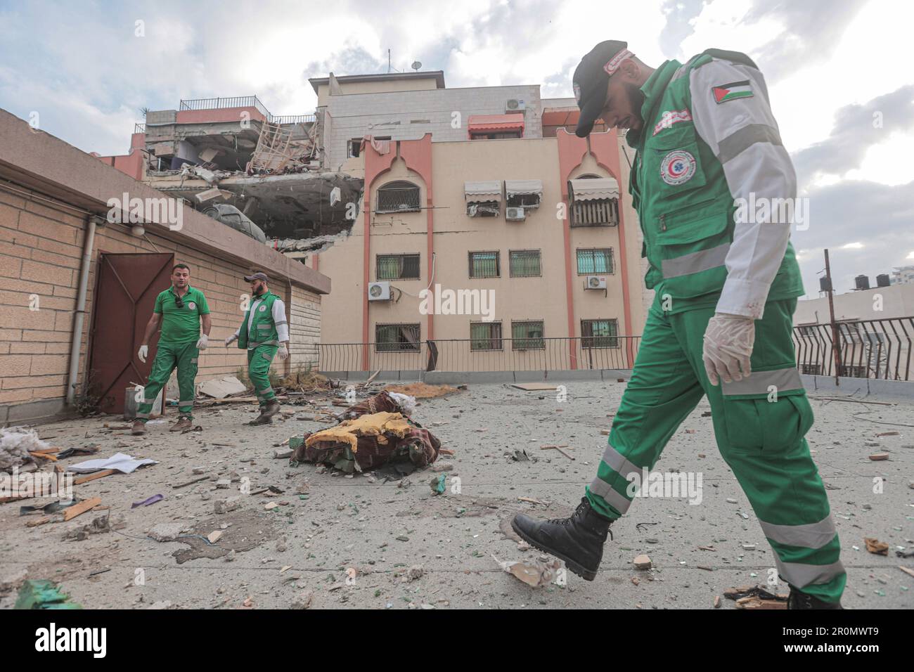 Gaza City. 09th May, 2023. Palestinian paramedics inspect damage in a ...