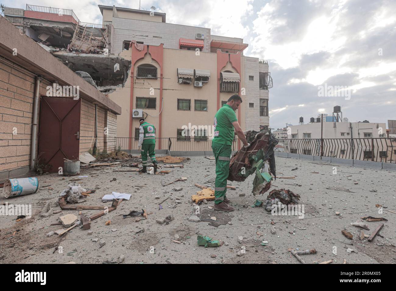 Gaza City. 09th May, 2023. Palestinian paramedics inspect damage in a ...