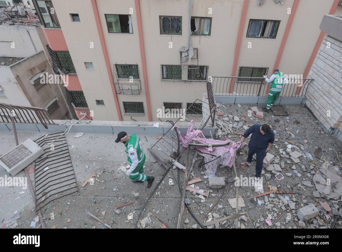 Gaza City. 09th May, 2023. Palestinian paramedics inspect damage in a ...