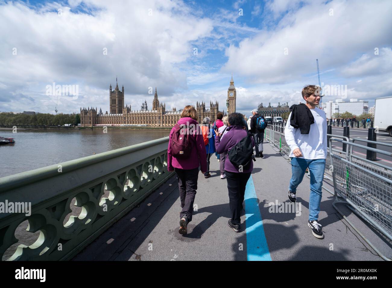 London UK. 9 May 2023. Pedestrians walking on Westminster bridge on day ...