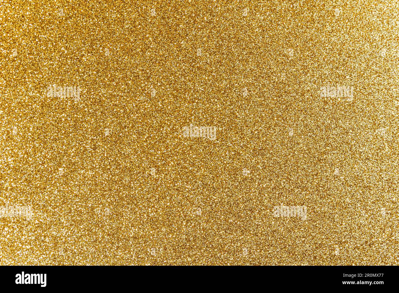 This image features a vibrant, lustrous gold glitter texture with ...