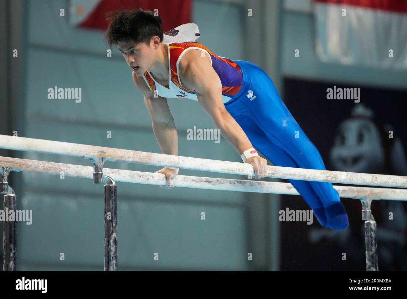 Philippines' Carlos Adriel Poquiz performs in the men's parallel bars ...