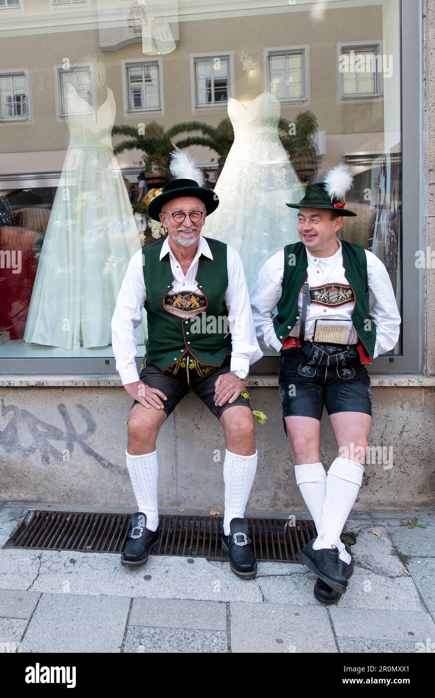 Gentlemen in Bavarian costume in front of shop window, entry of the ...