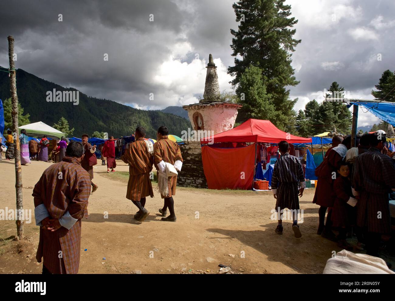 People at a fair on dirt road, feast at Gangteng Monastery, Phobjikha ...