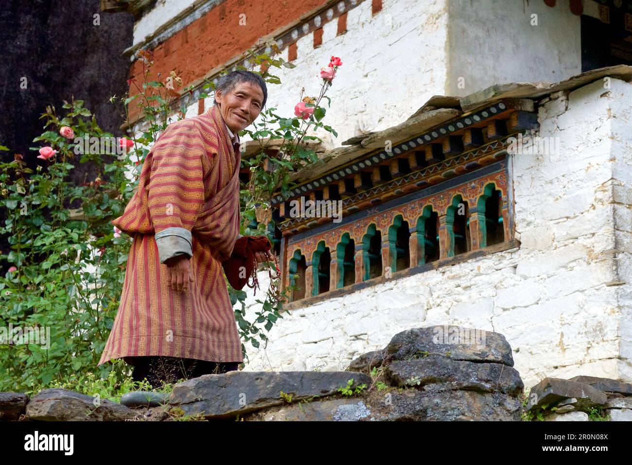 Bhutanese with prayer beads in front of the Ta Rimocen temple, Tang ...