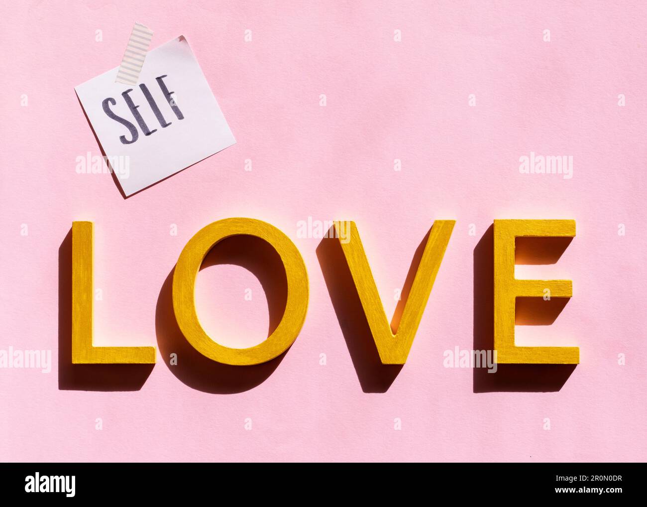 Creative self love text design inscribed on bright pastel pink ...