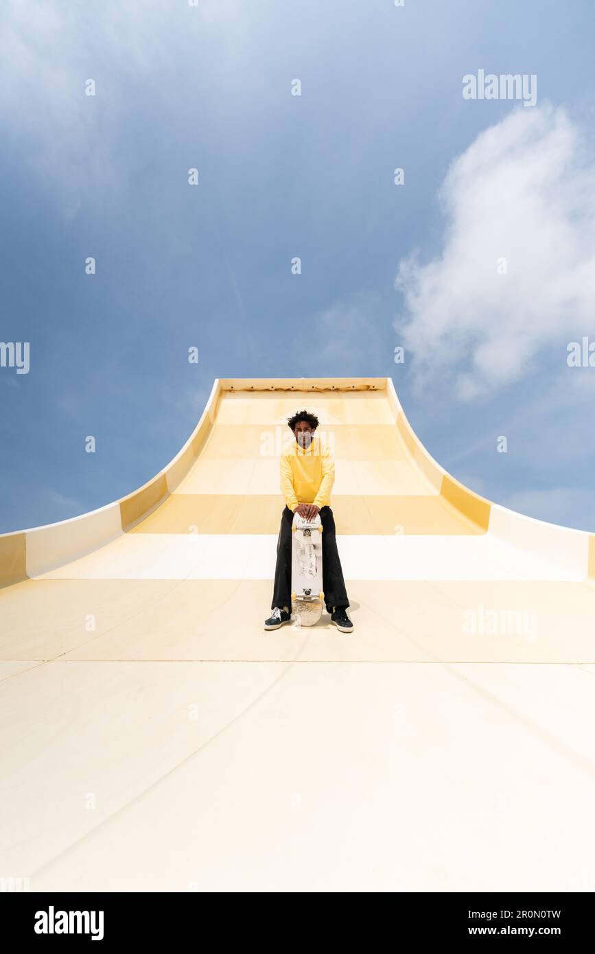 Full body front view of African American male skater in casual clothes ...