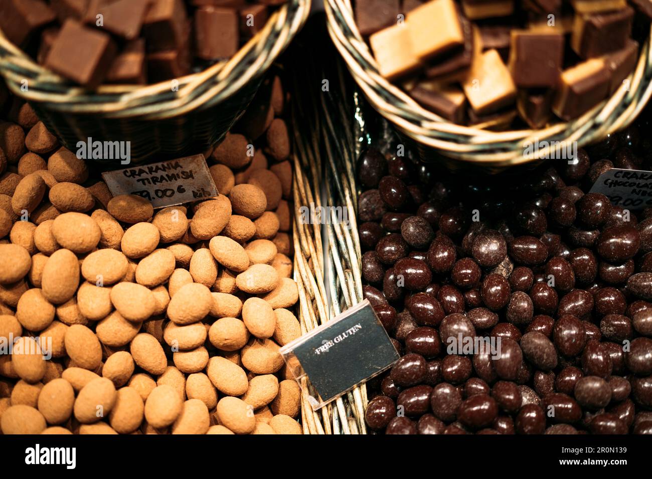 Top view of assorted heaps of glazed peanut placed in wicker baskets ...
