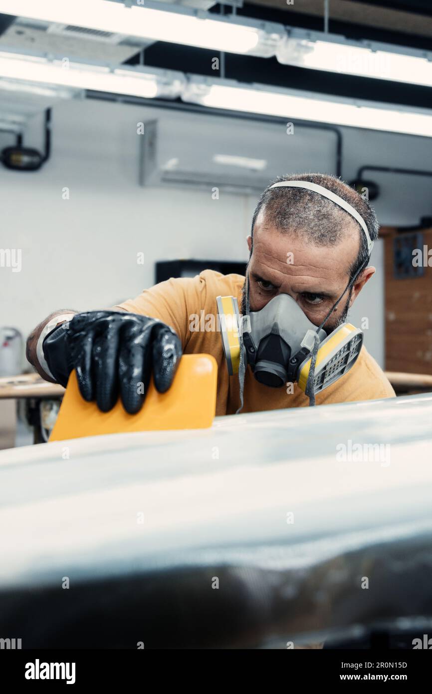 Concentrated male master in protective respirator and gloves using ...
