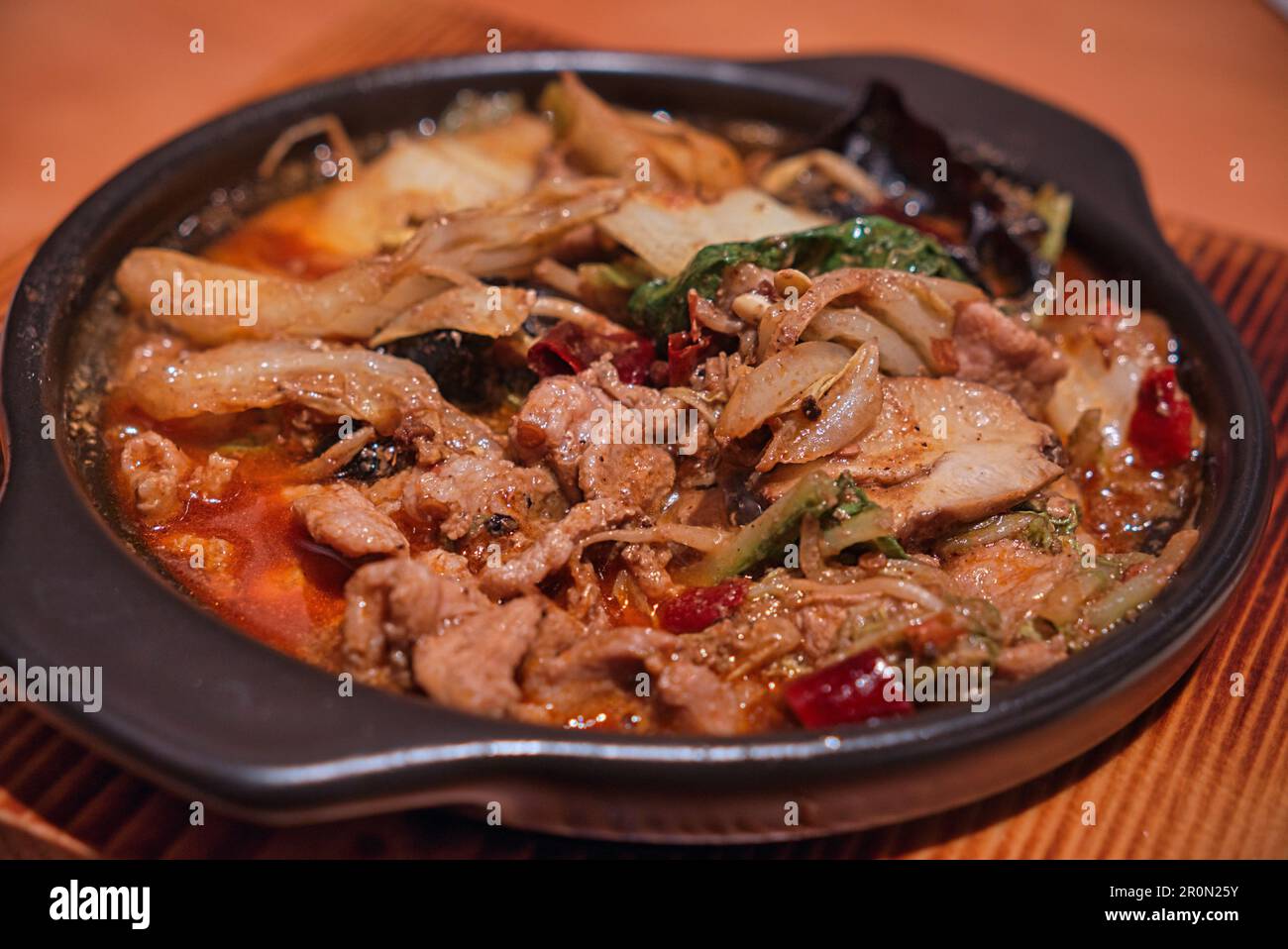 A black plate with a variety of traditional Chinese cuisine, including ...