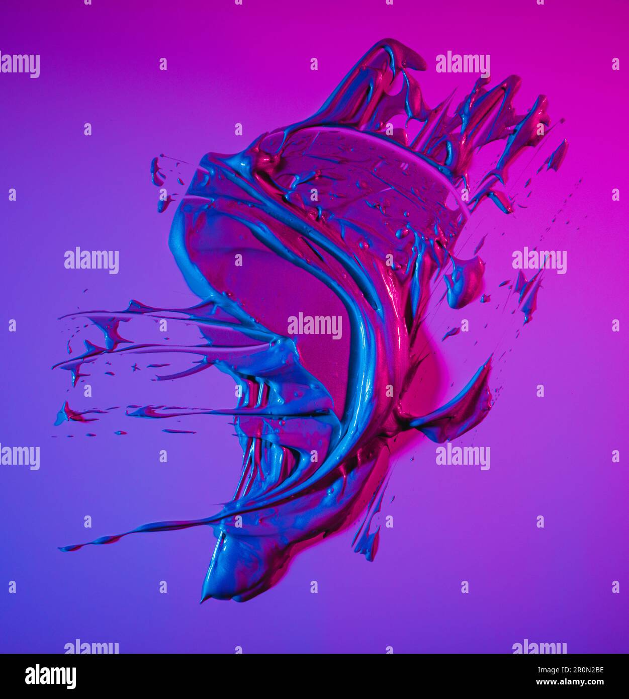 From above puddle of bright neon acrylic paint spread on vivid purple ...