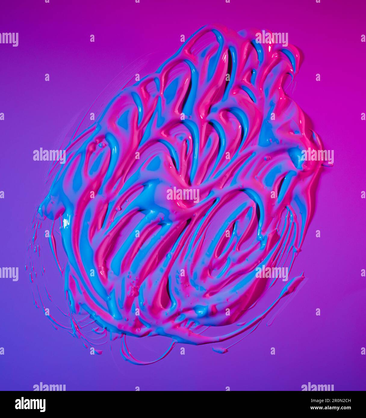 From above puddle of bright neon acrylic paint spread on vivid purple ...