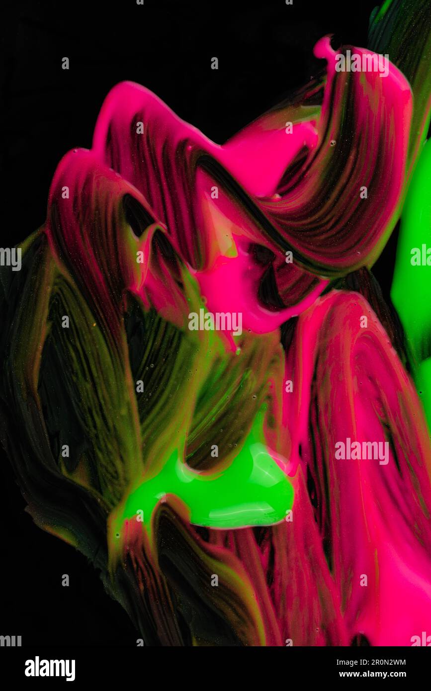 Closeup shot of spills of thick pigment of various colors mixing on ...