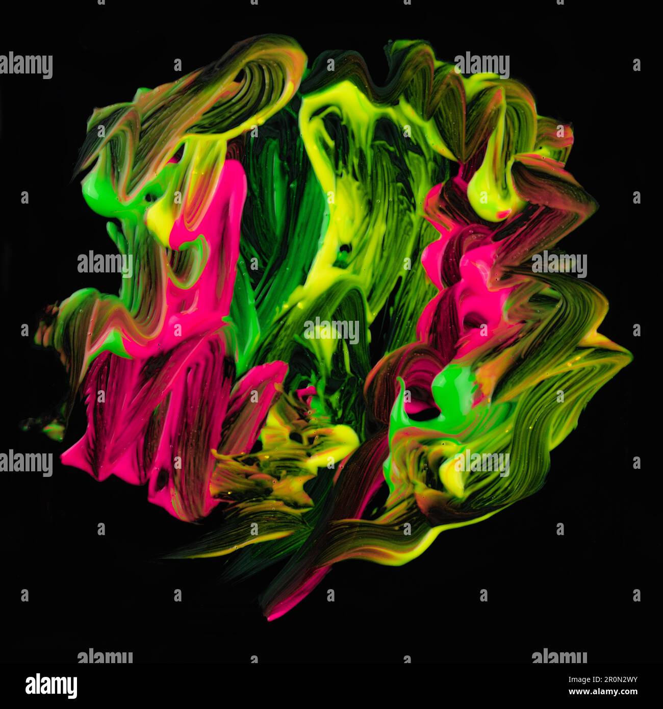 Closeup shot of spills of thick pigment of various colors mixing on ...