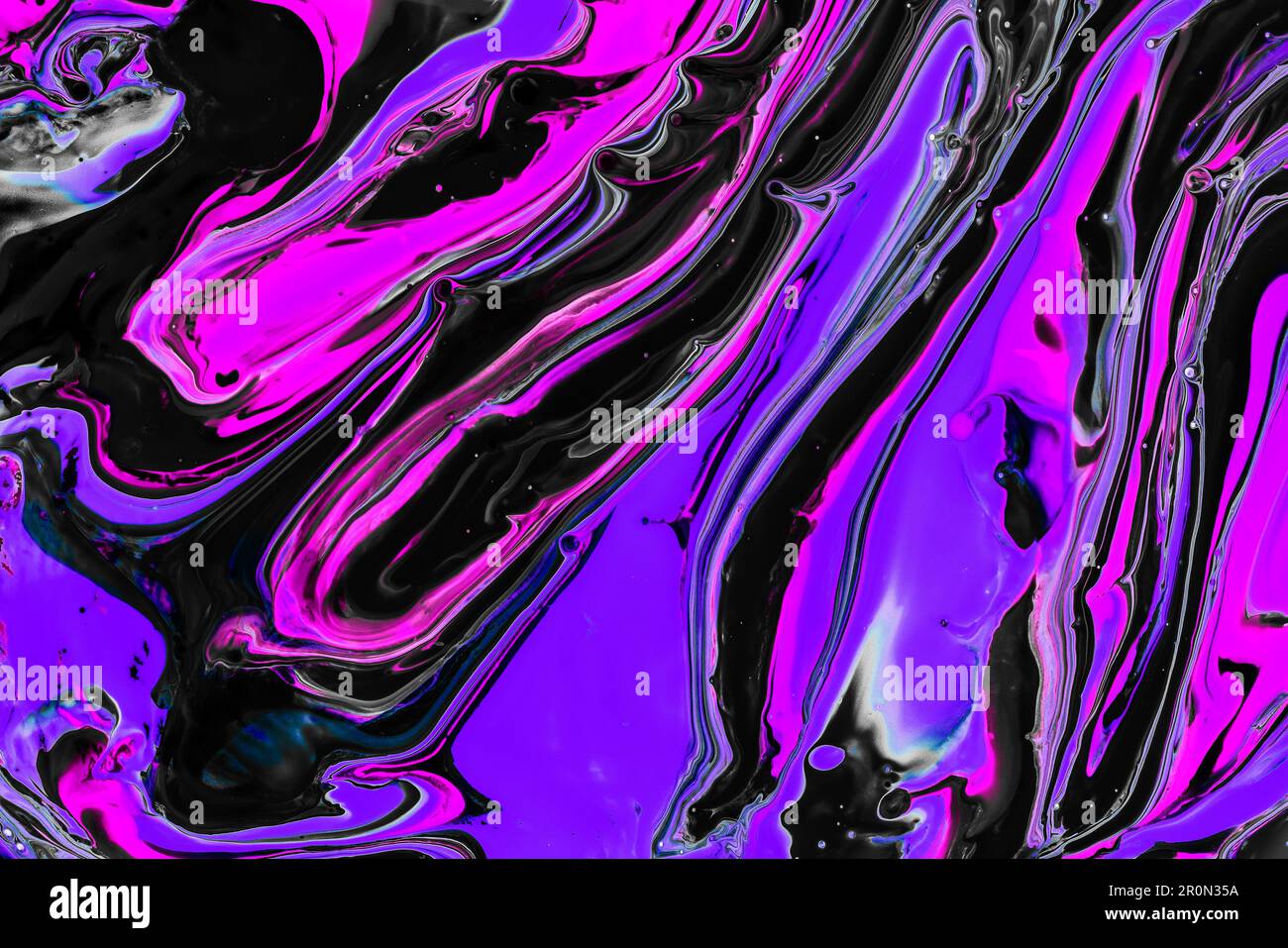 Close-up shot of thick paint of various bright colors flowing down and ...