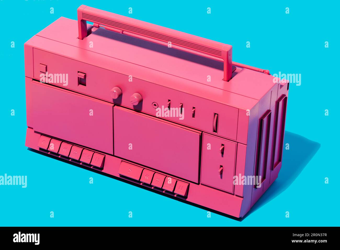 From above of bright pink retro cassette tape recorder placed in studio ...