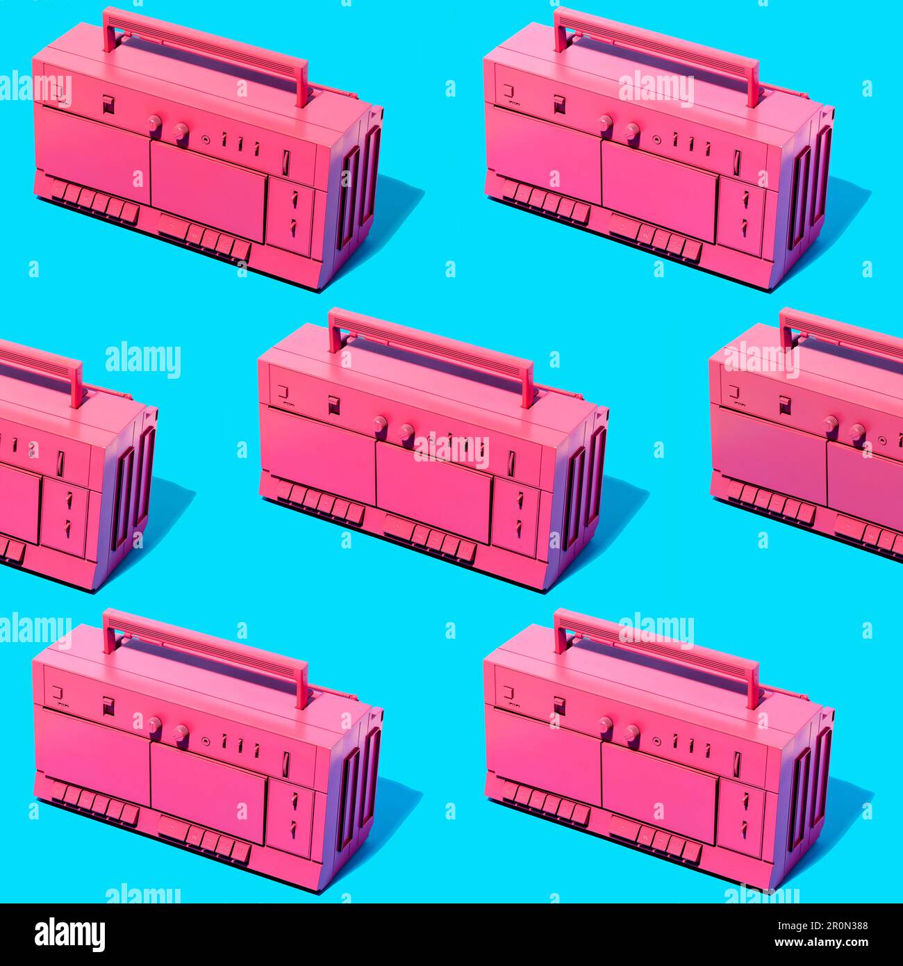 Pattern of set of similar pink retro tape recorder against blue ...