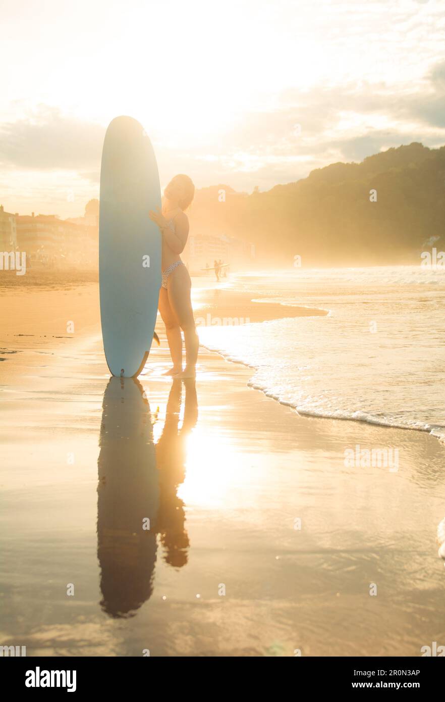 Full body of unrecognizable female surfer in swimsuit standing near ...
