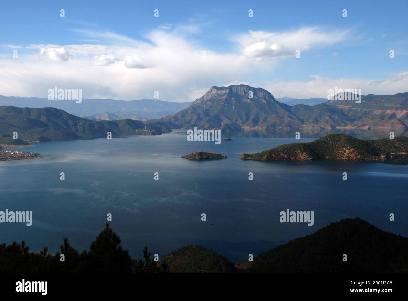 An empty ocean with its calm surface reflecting the blue sky above ...