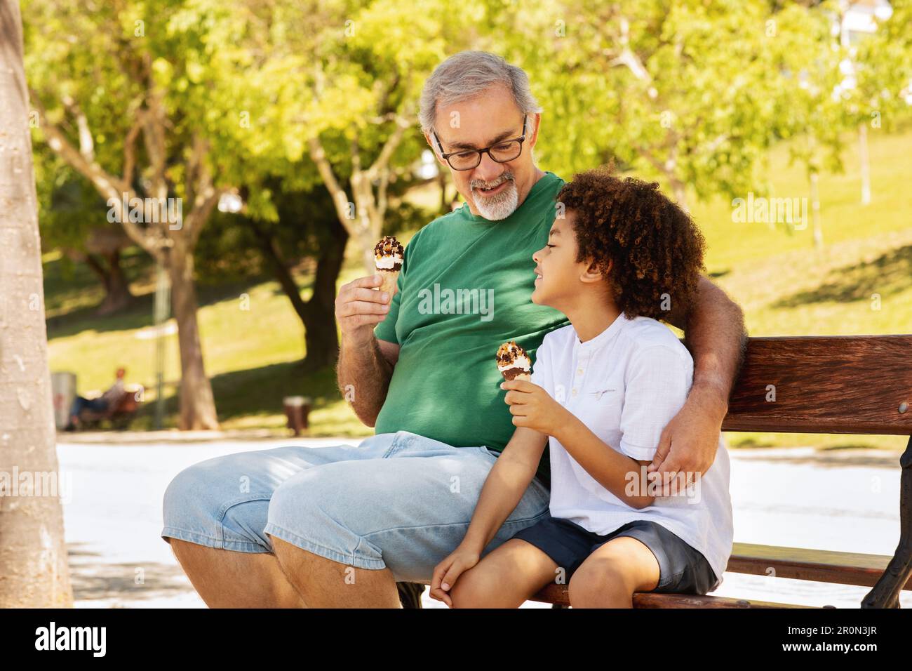 Happy little mixed race boy and old caucasian grandfather enjoy free ...