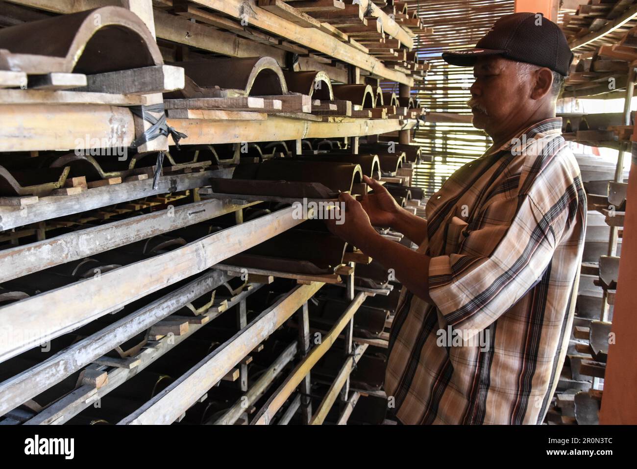Craftsmen print roof tiles at the tile industry center in Gulun Village ...