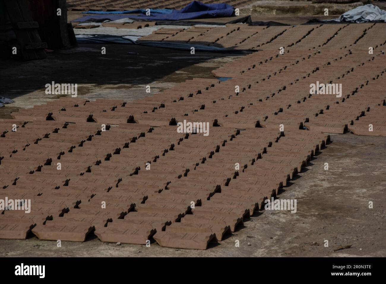 Craftsmen print roof tiles at the tile industry center in Gulun Village ...