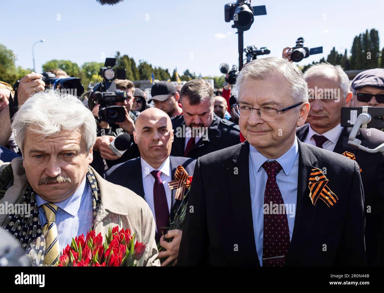 Russia's Ambassador to Poland Sergey Andreev, right, speaks to reporters in front of a memorial ...
