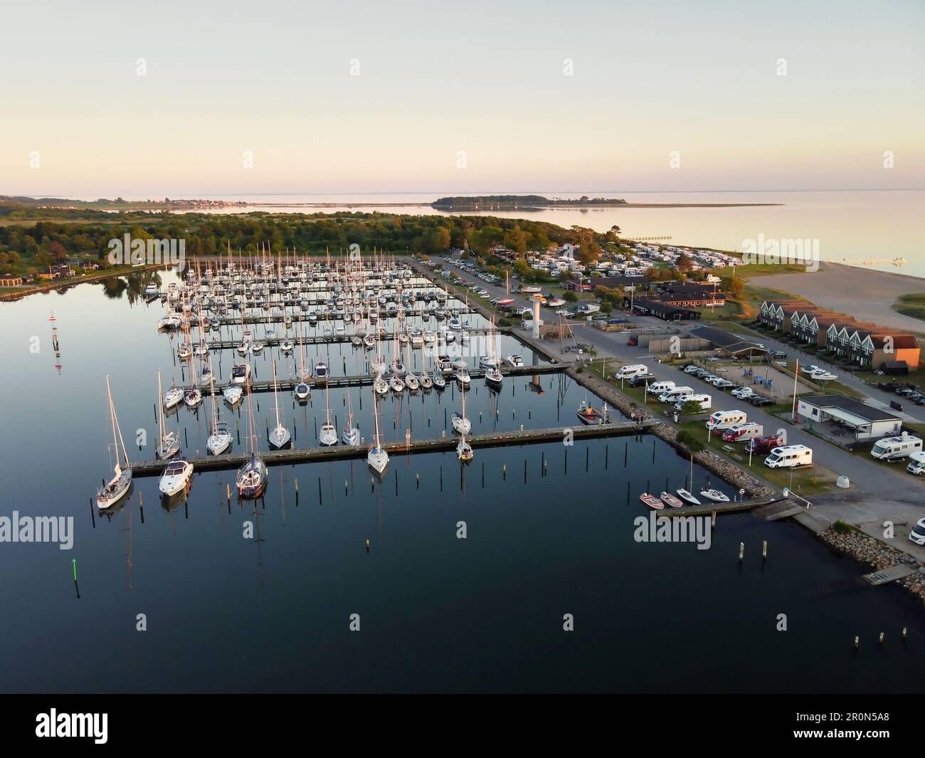 A picturesque marina with a variety of vessels and dwellings set ...