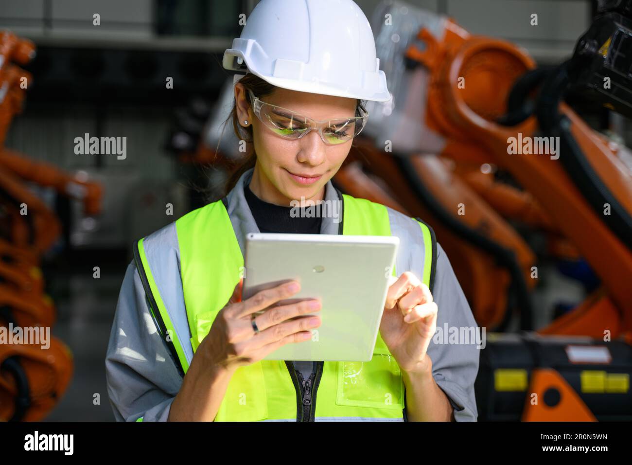 Maintenance engineer worker working with robotic machine automation ...