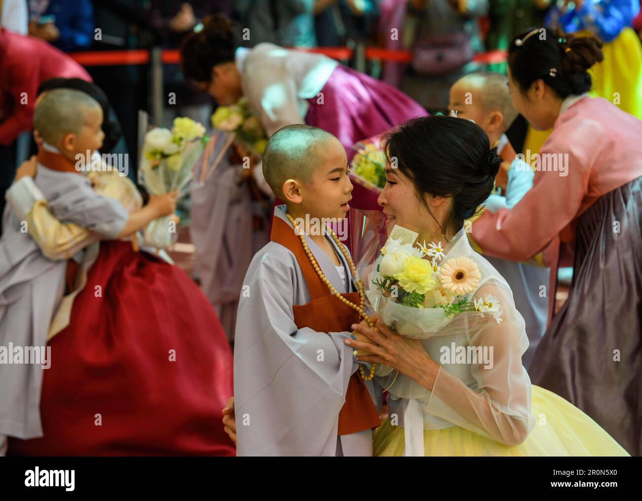 A South Korean child monk seen with his mother during an event to ...