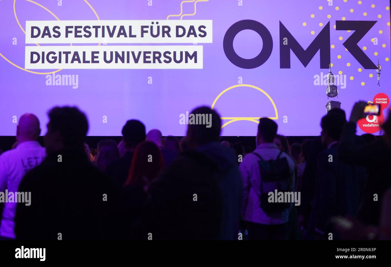Hamburg, Germany. 09th May, 2023. Trade show visitors walk into an exhibition hall at the OMR ...